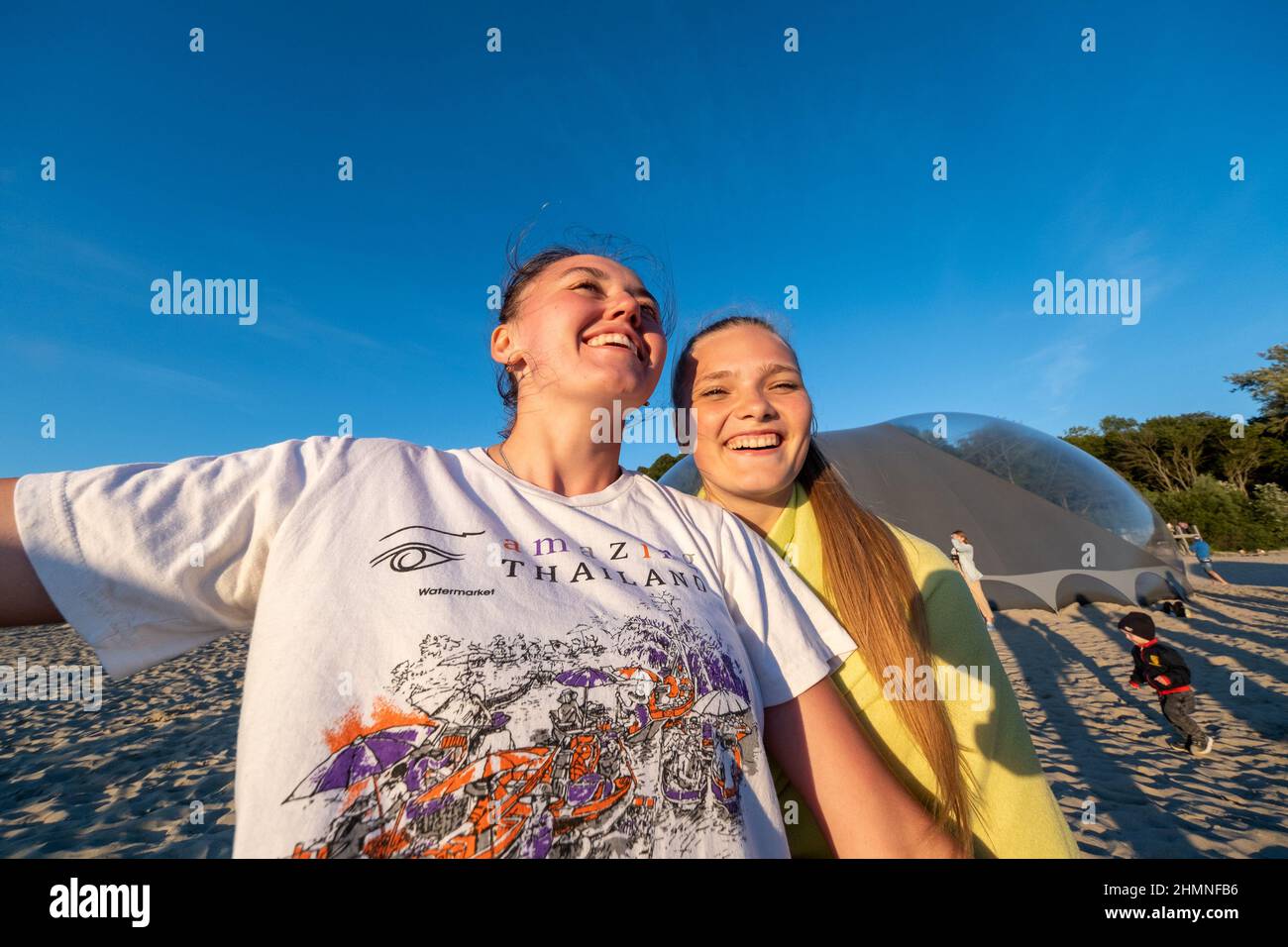 Smiling women on sandy beach Stock Photo - Alamy