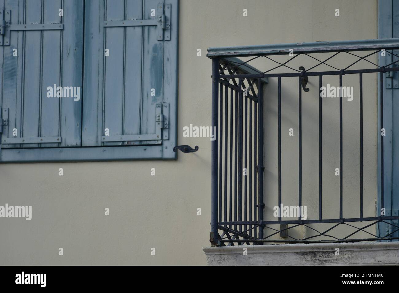 Traditional rural house facade with light blue wooden window shutters ...