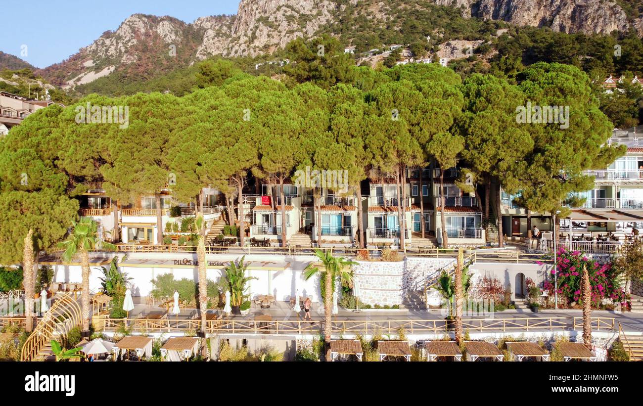 Aerial view of tourist hotel with with planted pines in resort village ...