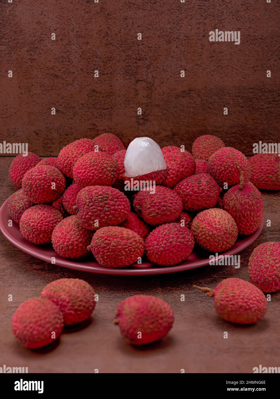 The photo shows tropical red fruits - lychee. Exotic food is set ...