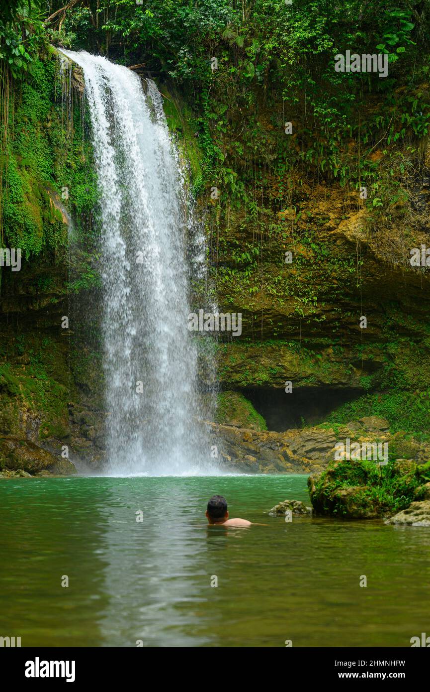 The photo shows a huge waterfall. Below is a perfectly clear water ...