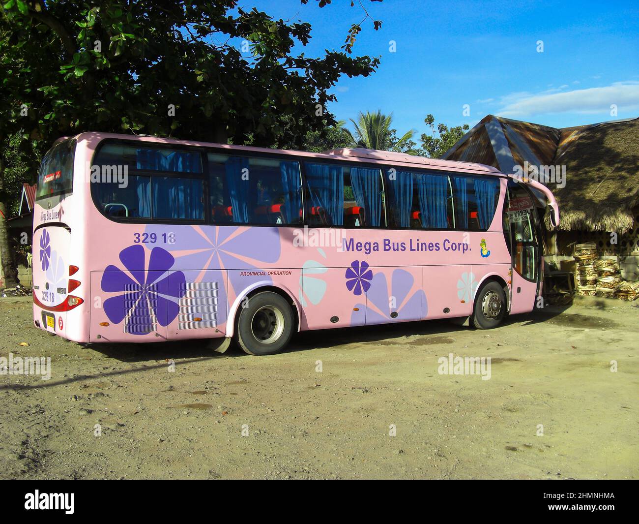 Domestic bus is parking in front of a building in Samar on the ...