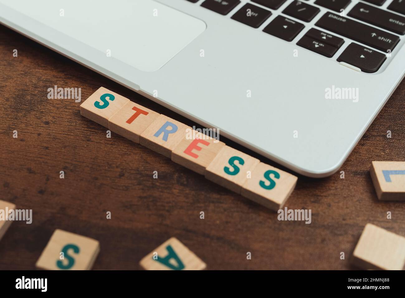 Stress word written on wooden letter cubes tiles - computer desk and ...
