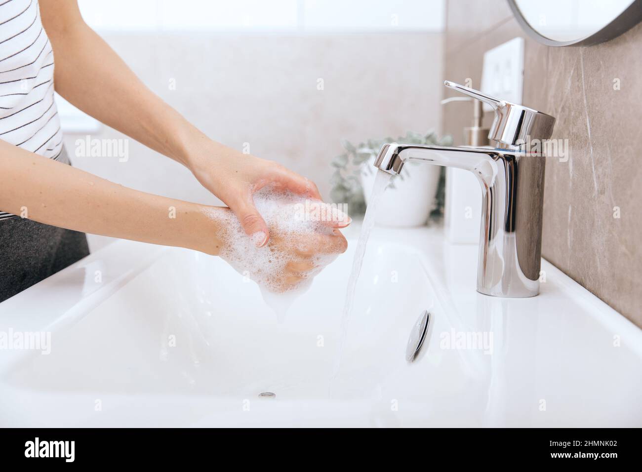 Washing hands under the flowing water tap. Washing hands rubbing with ...