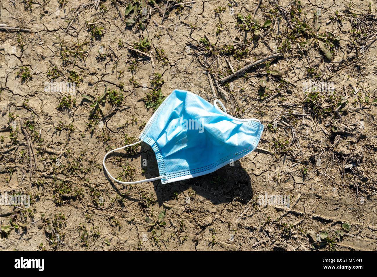Top view of a face mask lying on the ground of a sandy field Stock ...