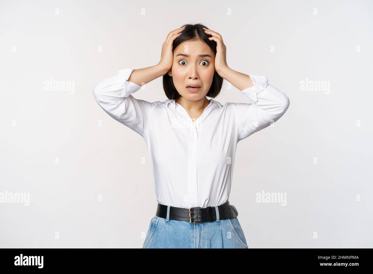 Image of shocked anxious asian woman in panic, holding hands on head ...