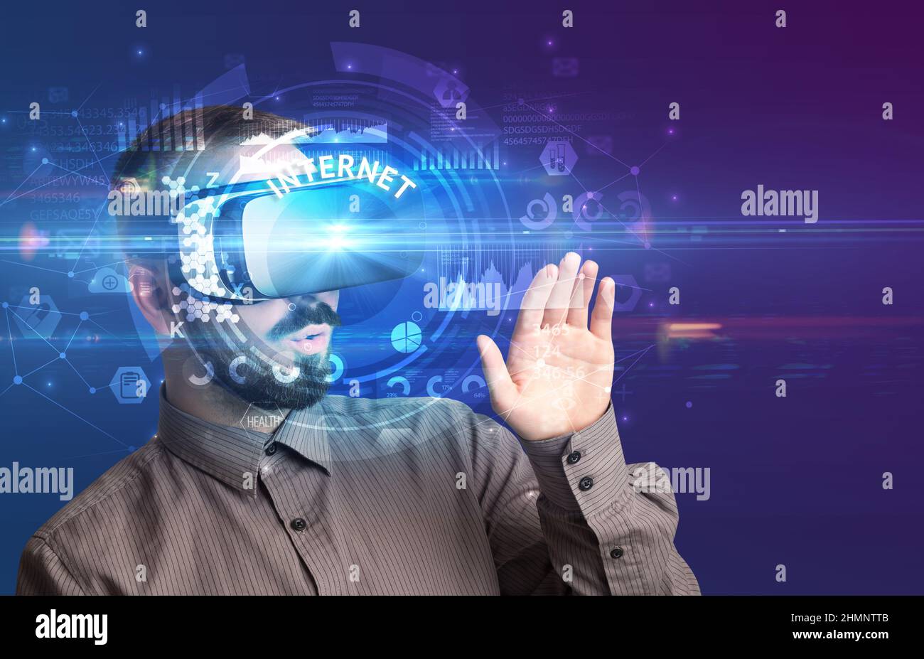 Businessman looking through VR glasses Stock Photo - Alamy