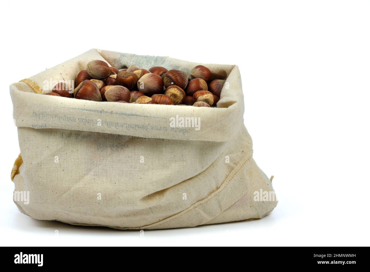 Hazelnuts in burlap sack isolated on white background. Profile, side ...