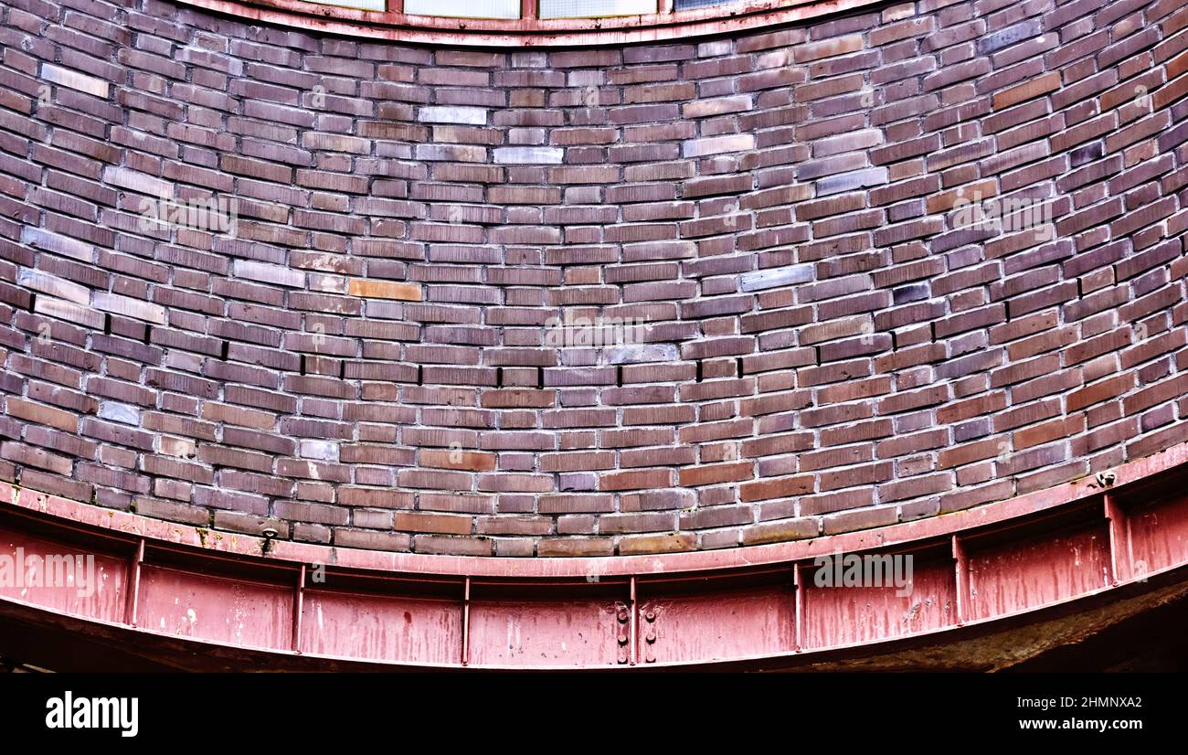 Curved wall from old bricks on a red steel beam Stock Photo - Alamy