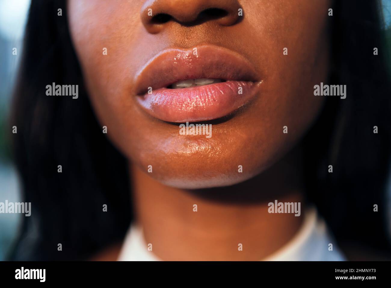 close-up detail of the full-lipped mouth of a young african woman, copy ...