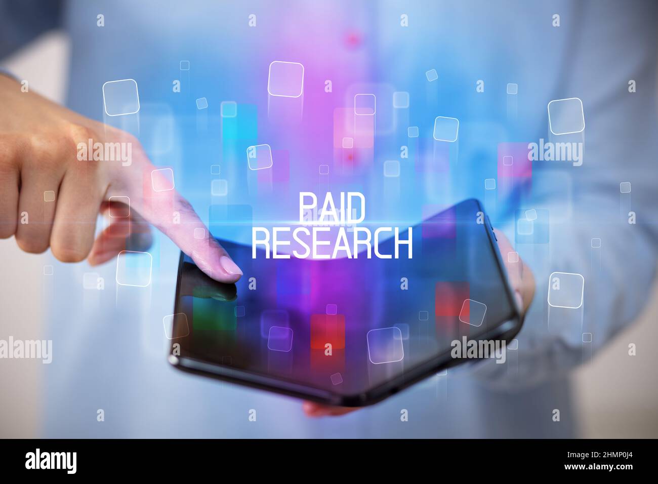 Young man holding a foldable smartphone Stock Photo - Alamy