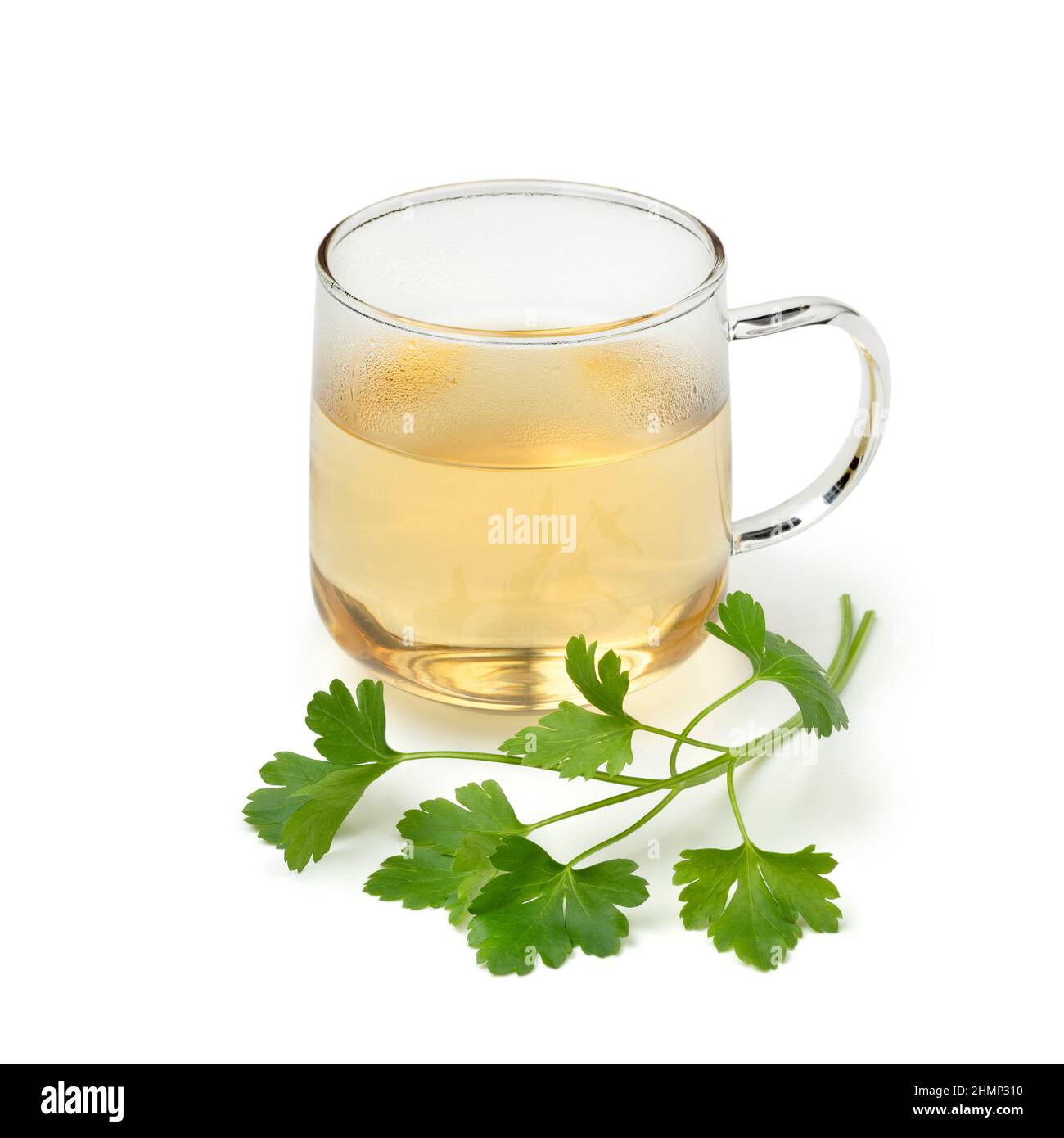 Glass with healthy fresh parsley tea close up isolated on white ...