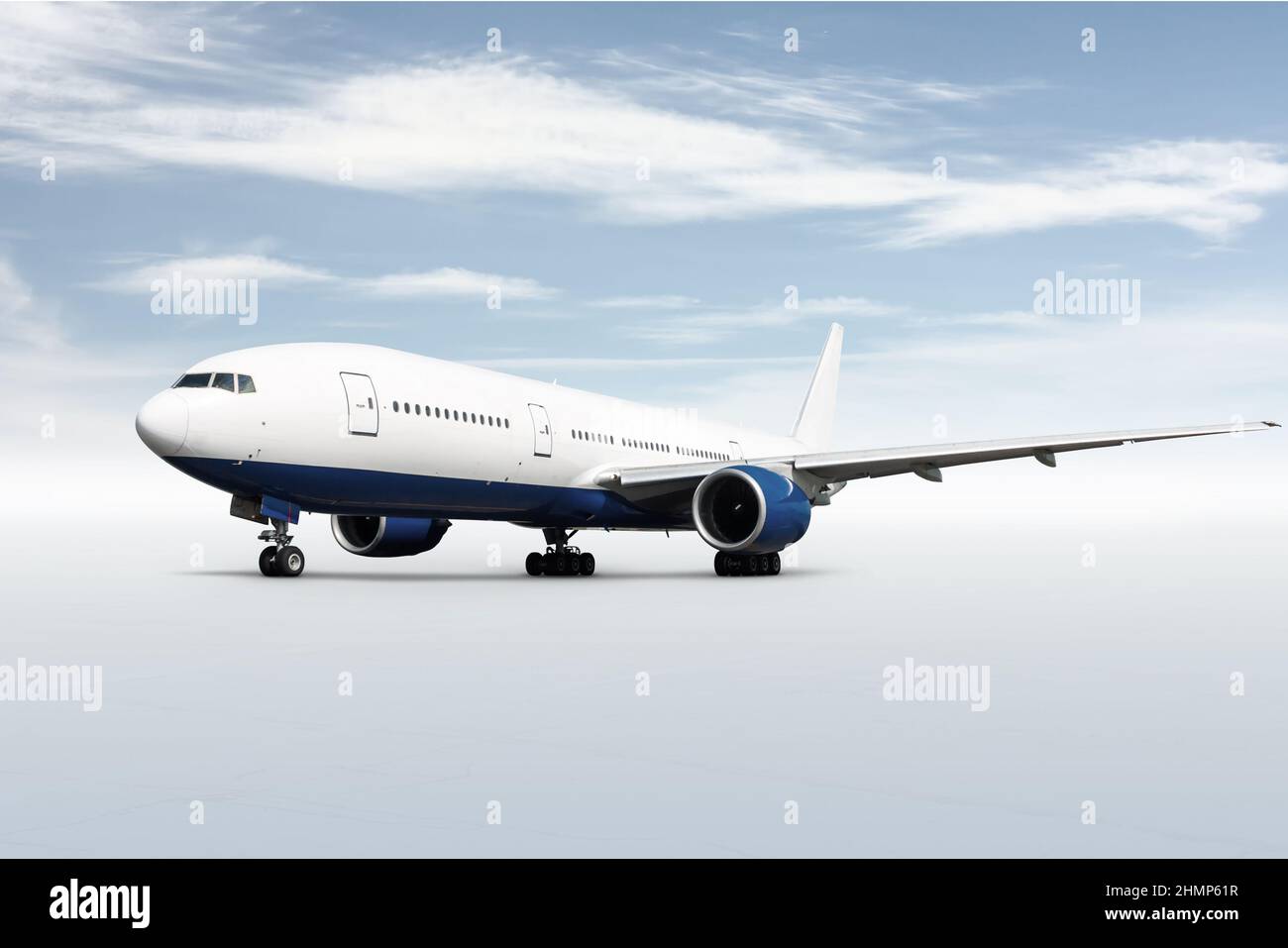 Wide body passenger aircraft isolated on bright background with sky ...