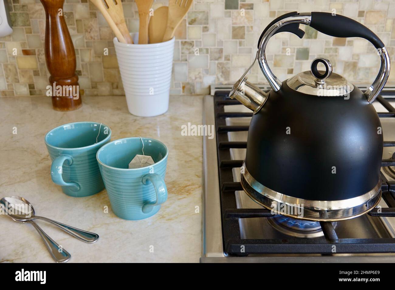 preparing a hot cup of tea in the kitchen Stock Photo - Alamy