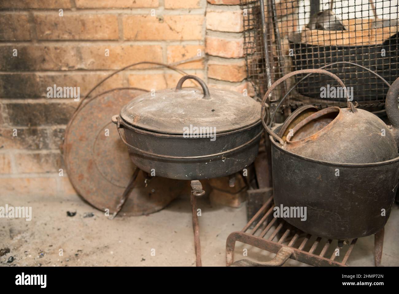 Cast iron cookware on colonial hearth Stock Photo - Alamy