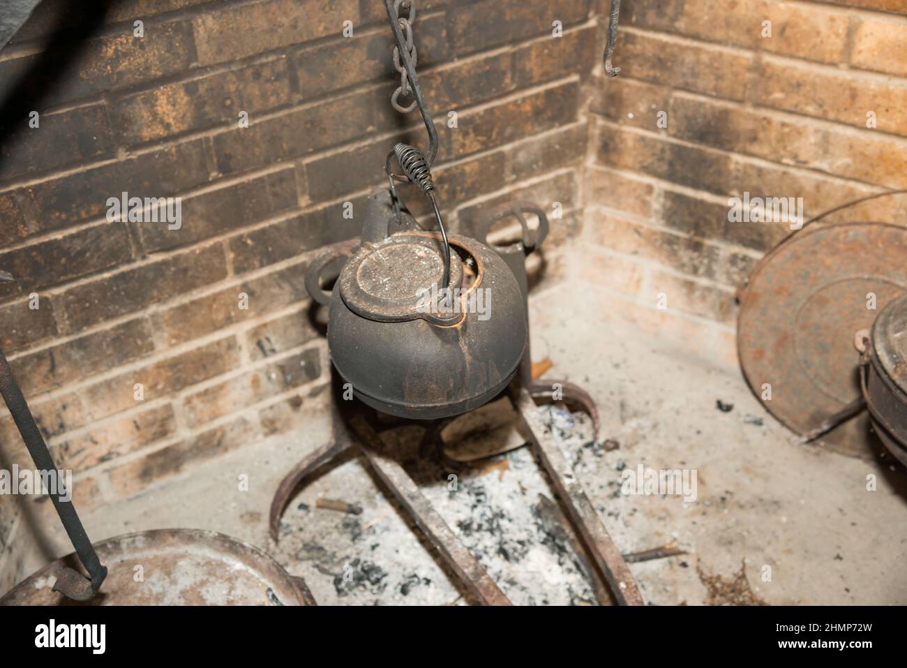 Cast iron cookware on colonial hearth Stock Photo - Alamy