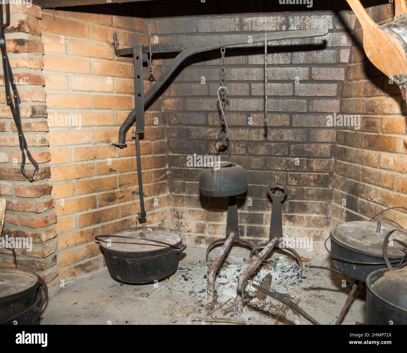 Cast iron cookware on colonial hearth Stock Photo - Alamy