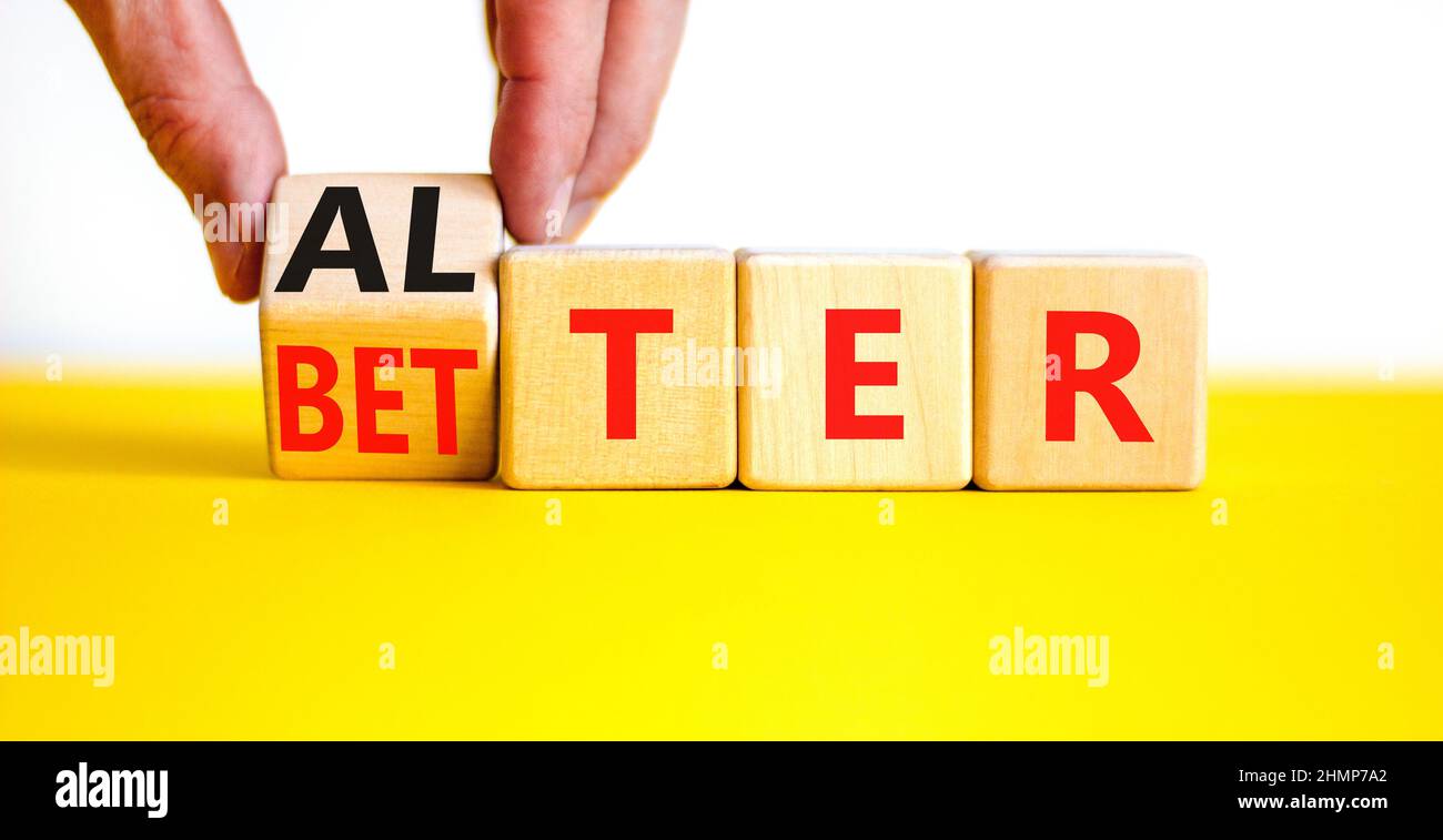 Alter or better symbol. Businessman turns wooden cubes and changes the ...