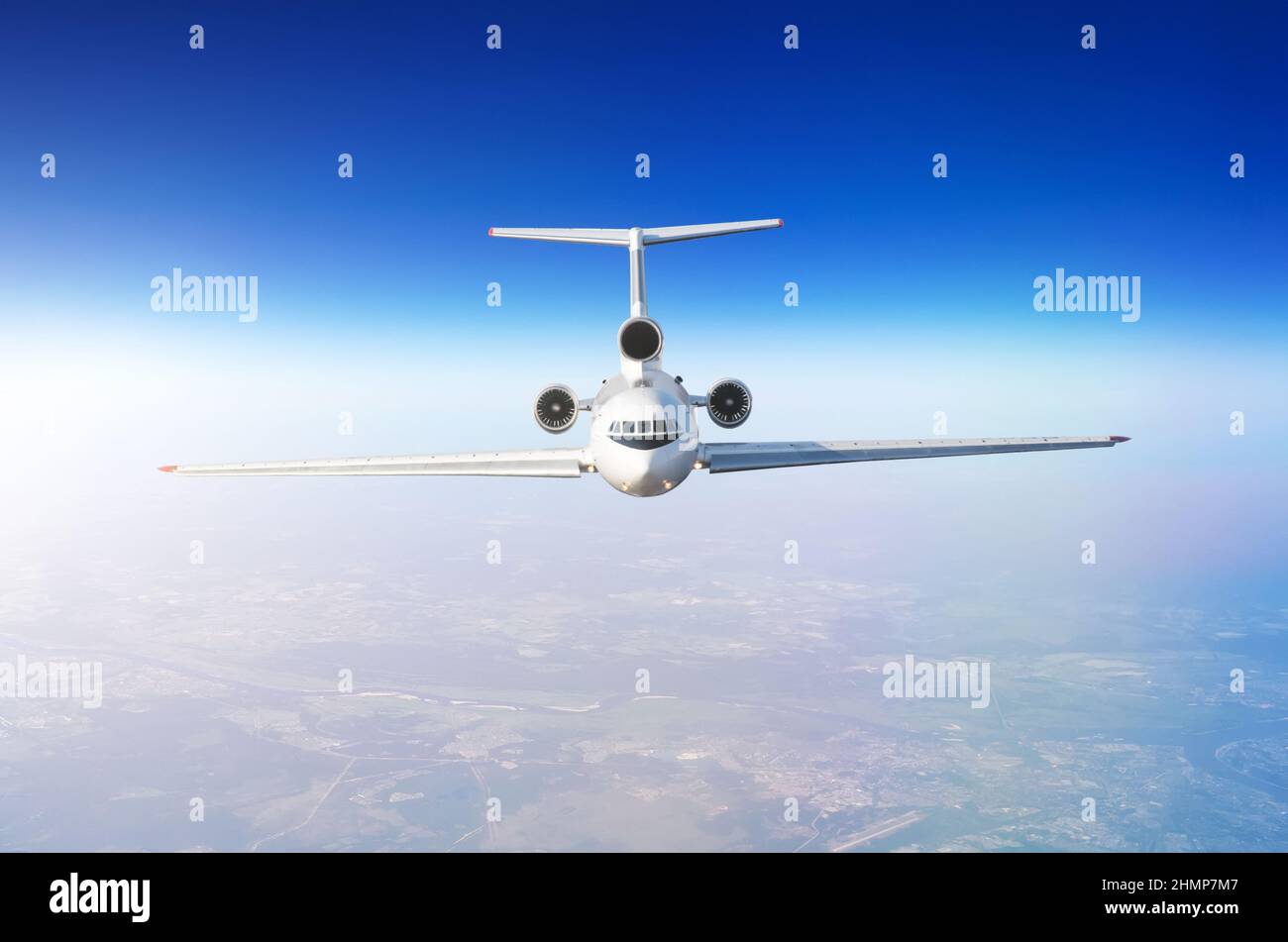 White airplane flies climbs height, flight level high in the sky above ...