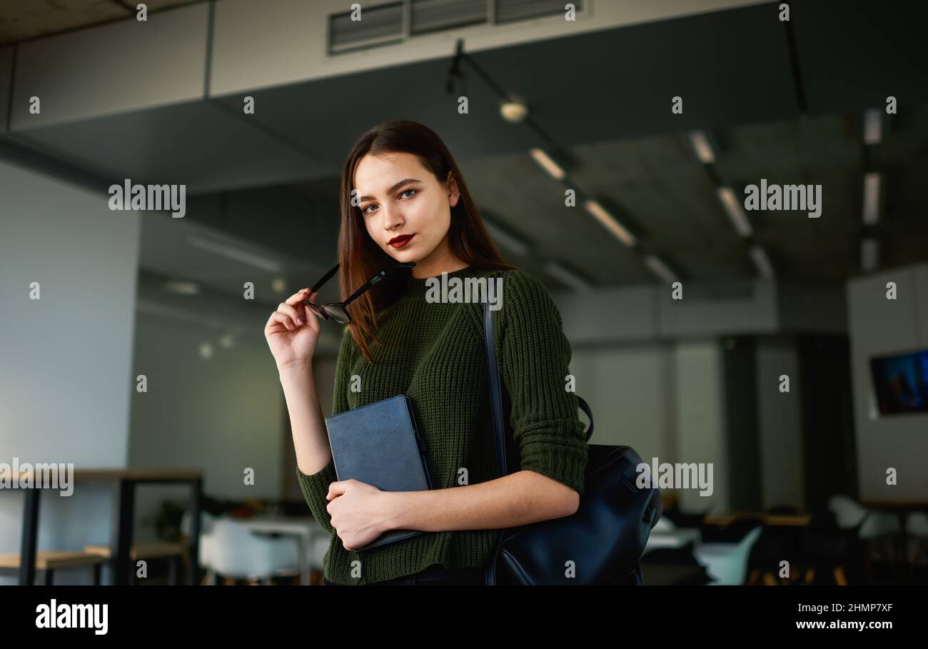 Student with notebook and bag in cafe Stock Photo - Alamy