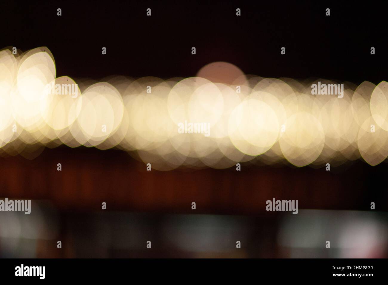 Bokeh lights forming one line on black background Stock Photo - Alamy