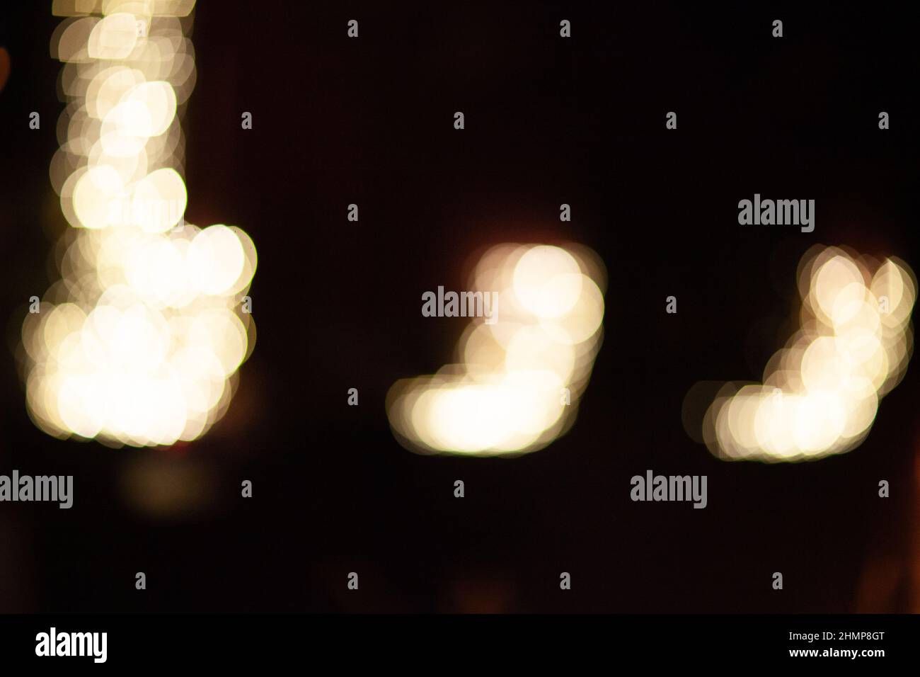 Bokeh lights forming three random spots on black background Stock Photo ...
