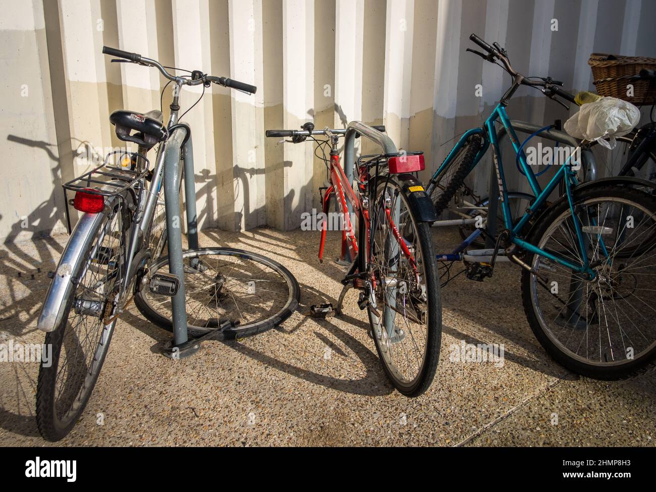 Damaged and vandalised bicycles take up space on a bike parking stand ...