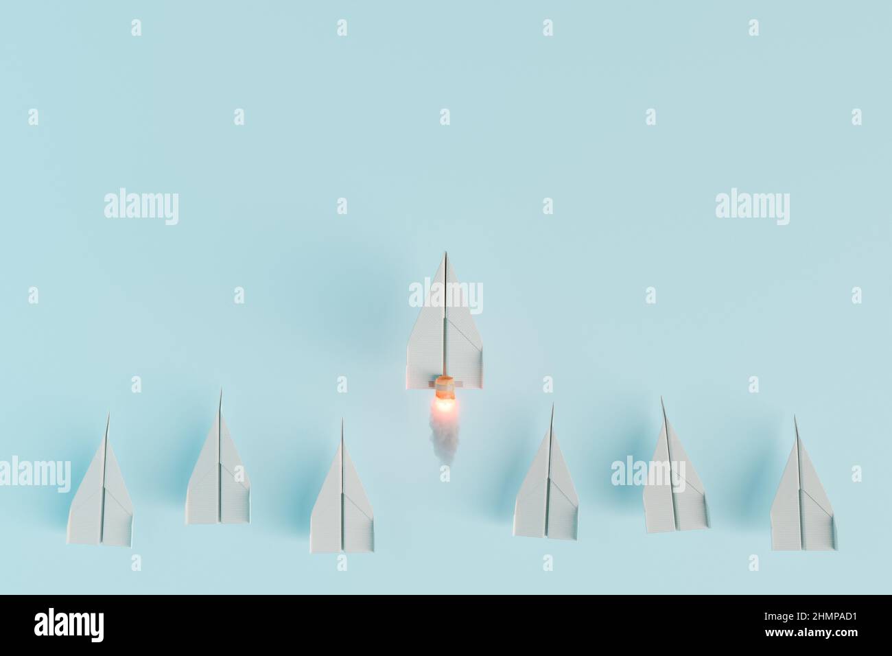 paper airplanes in line with one propelled and moving faster. concept ...