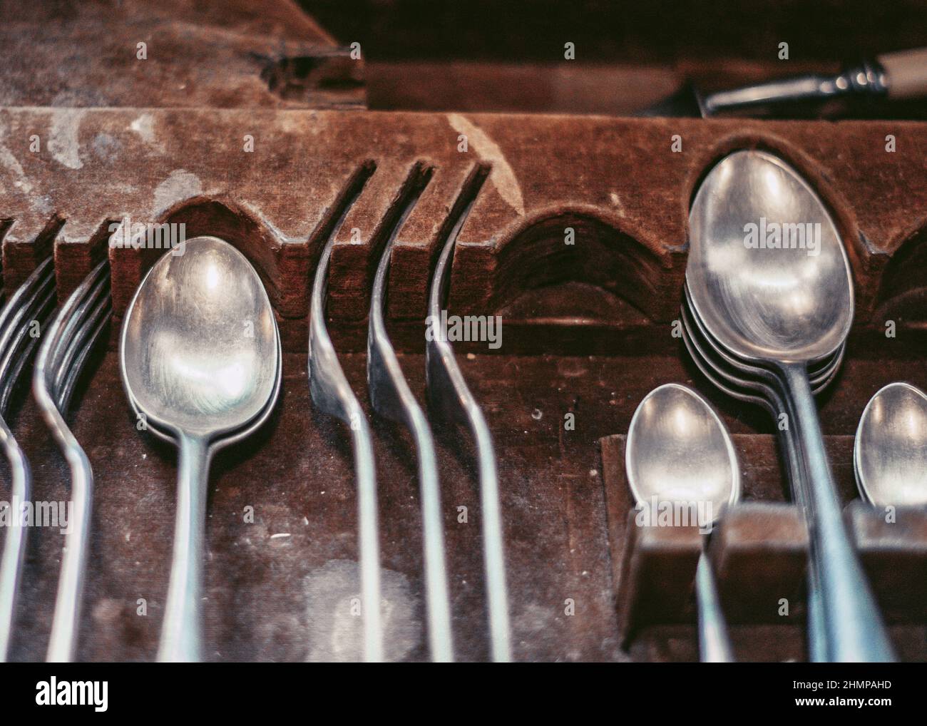 Vintage cutlery in vintage wooden box. Soft focus background, close up ...