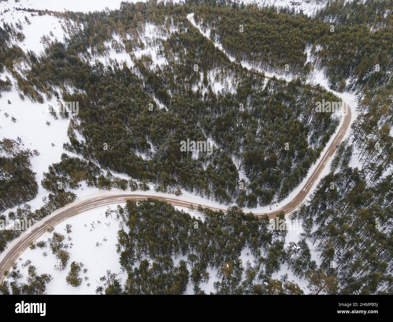 Winding Road In Winter Landscape. Aerial view from drone of road among ...