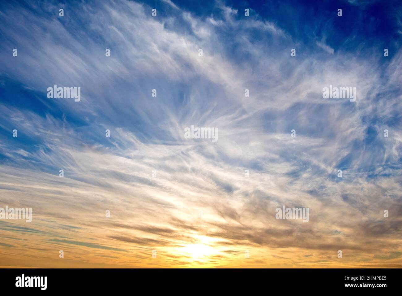 A dramatic sky at the end of a winters day, the blue streaked with high ...