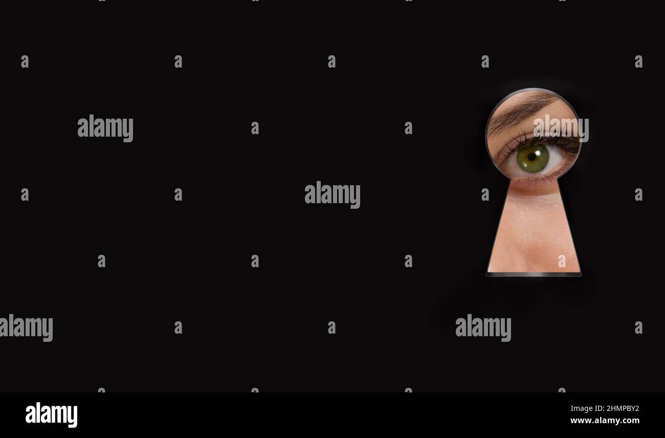 Abstract keyhole opening with eye on black background. Access and ...