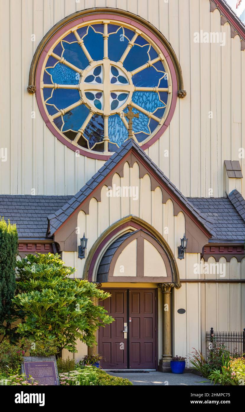 Circle shape stained glass window on facade of a church. Exterior of a ...