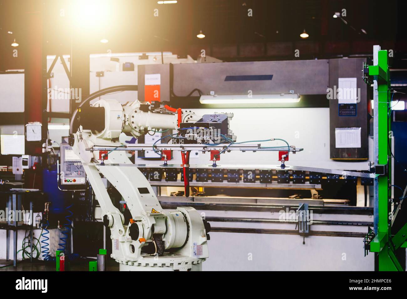 Robotic arm working with metal sheet at hydraulic bending machine Stock ...