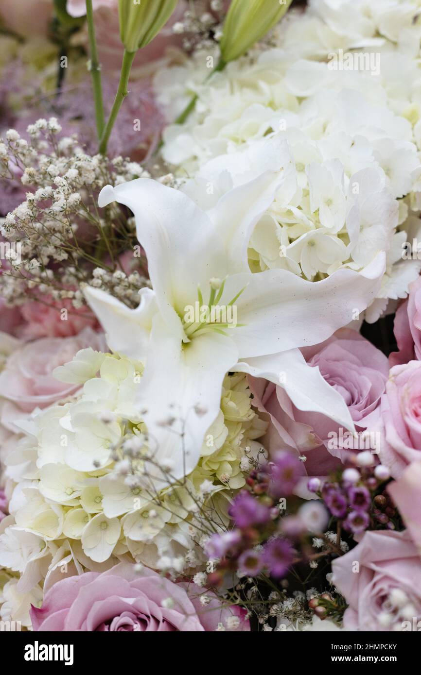 Floral arrangement featuring a tightly packed bunch of pink and cream ...