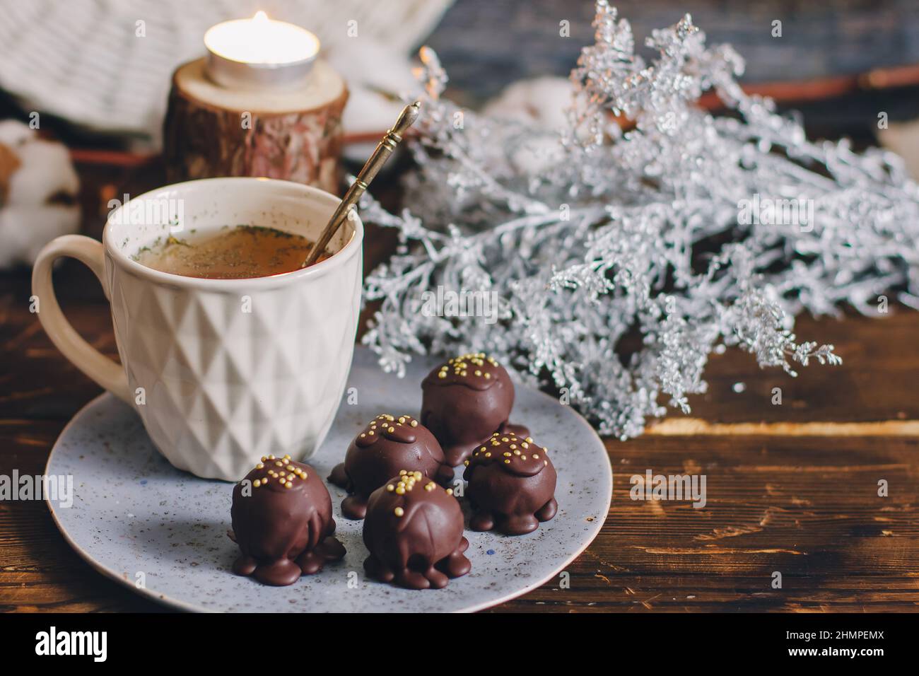 Dark chocolate handmade candy balls on handmade plate on dark wooden ...