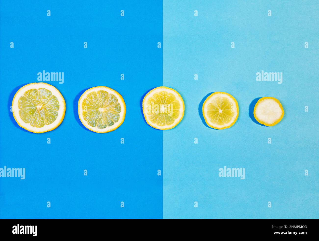 Five slices of lemon on blue-cyano background ,different roundish shape ...
