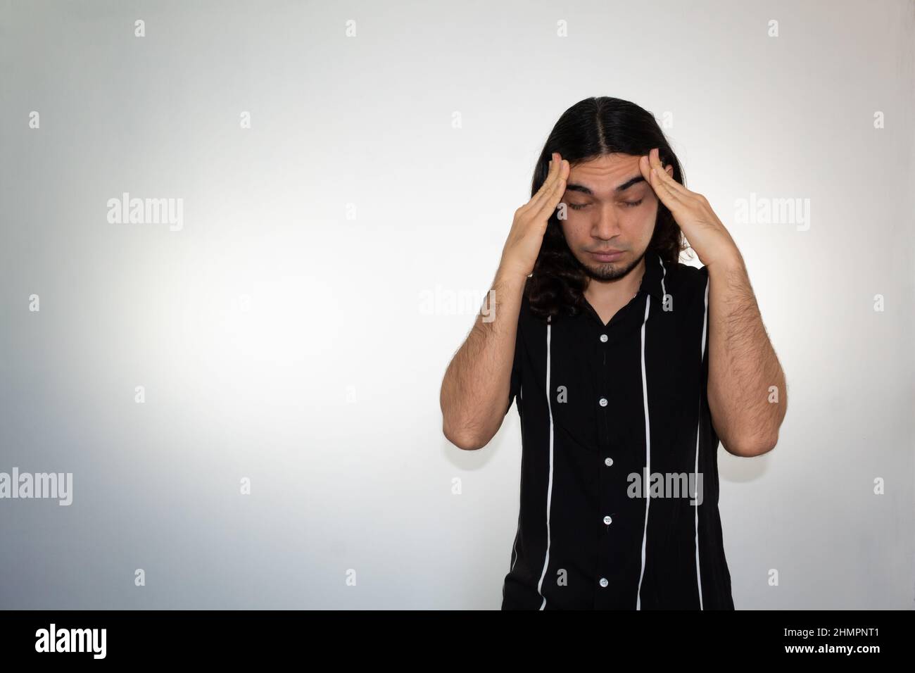 portrait of a hispanic man with a headache, stress and frustration on a ...