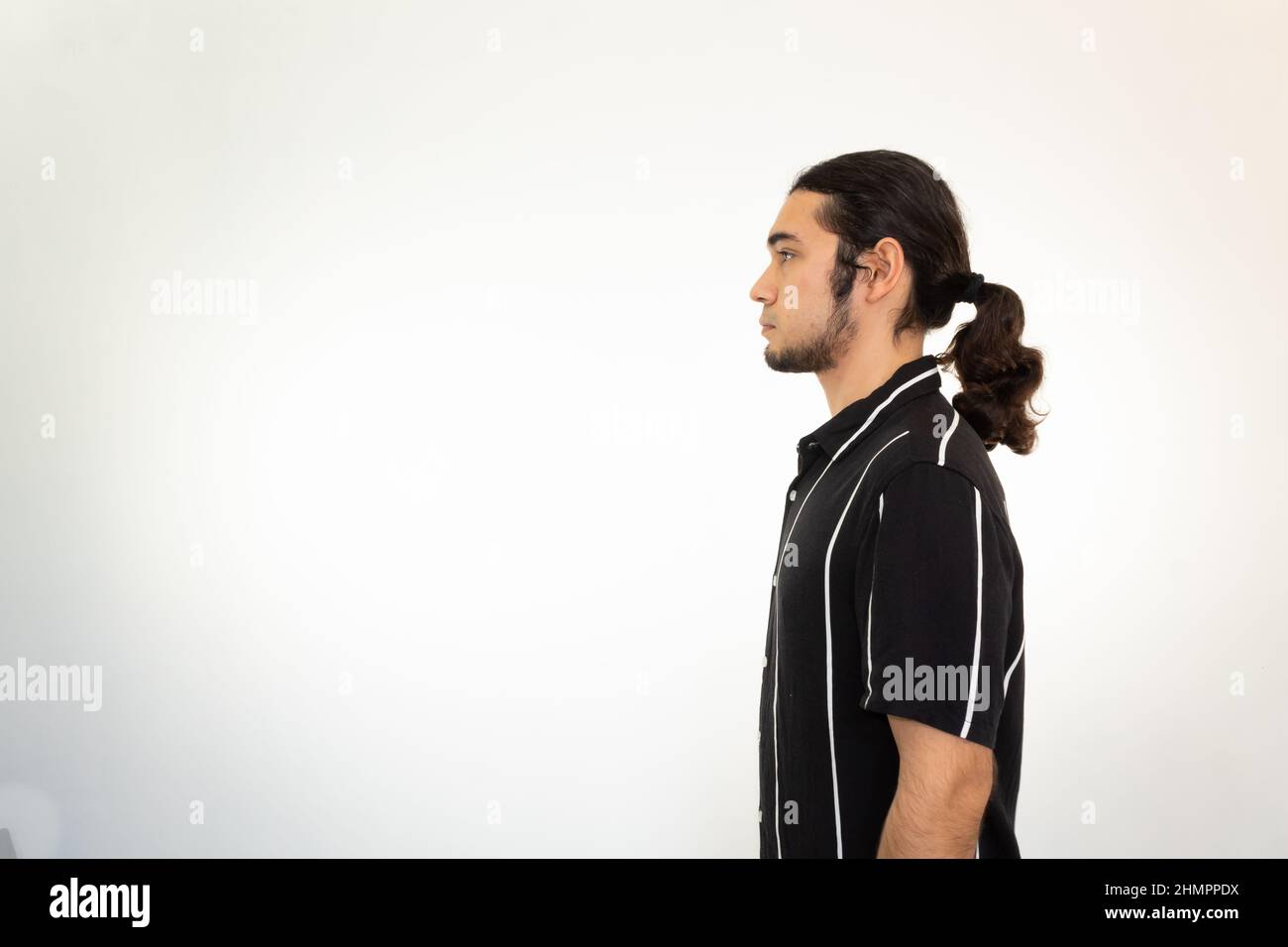 portrait of a hispanic non binary man on a white background Stock Photo ...