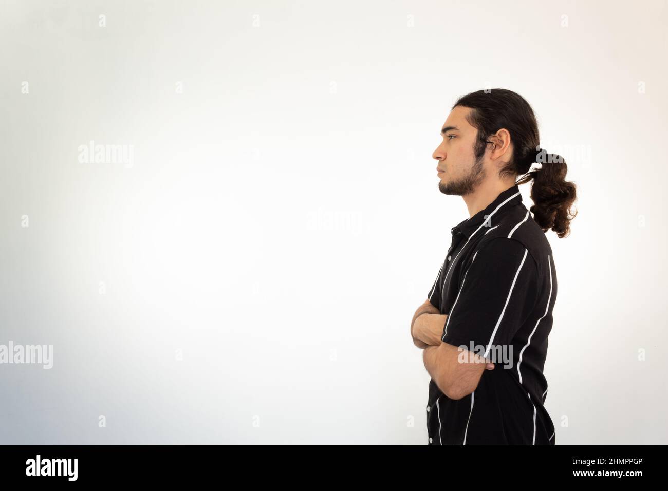 portrait of a hispanic non binary man on a white background Stock Photo ...