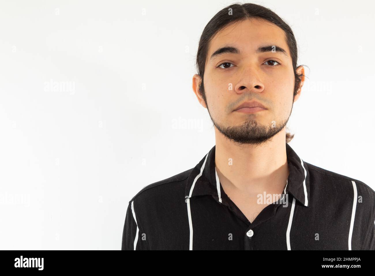 portrait of a hispanic non binary man on a white background Stock Photo ...