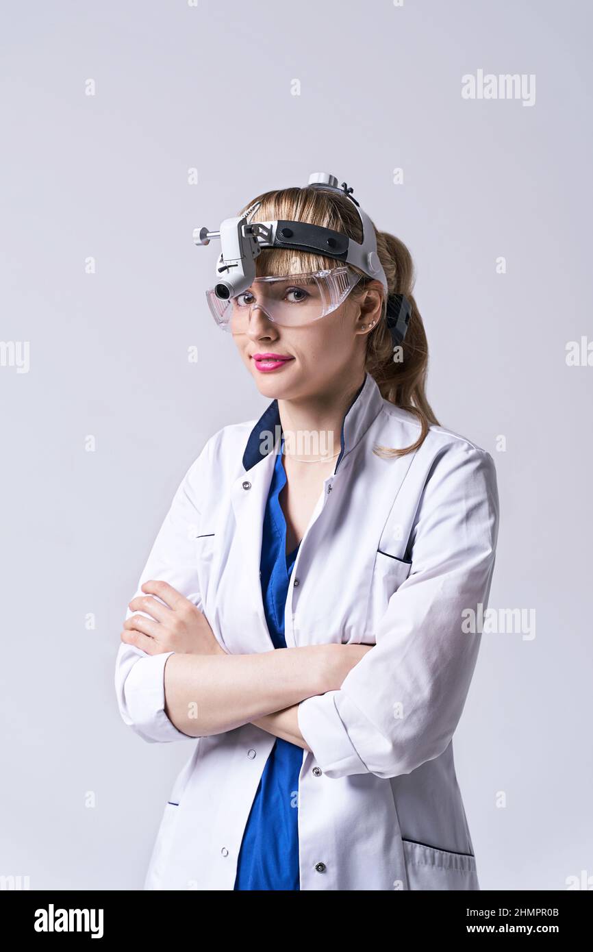 Confident ENT doctor wearing surgical headlight head light and ...