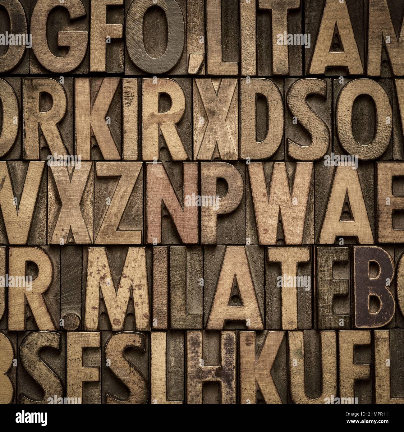 background of random vintage letterpress printing blocks stained by ...