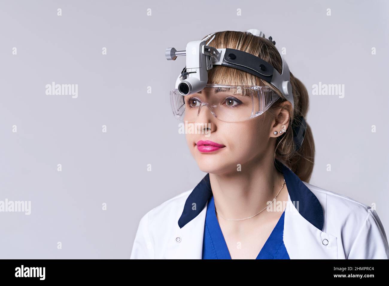 Confident ENT doctor wearing surgical headlight head light and ...