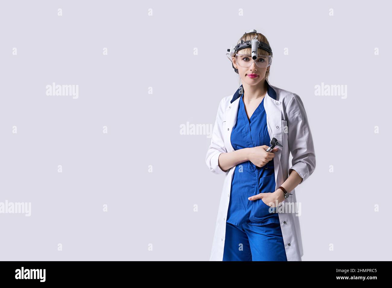 Confident ENT doctor wearing surgical headlight head light and ...