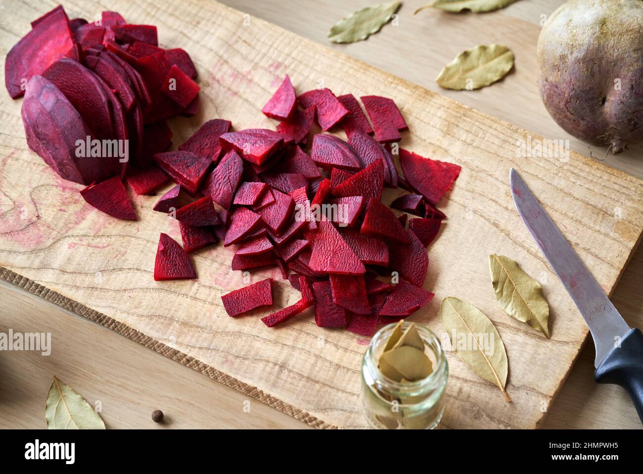 Cut up red beets with bay leaf and allspice - preparation of homemade ...