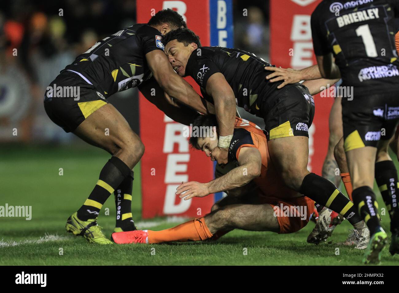 Jake Mamo #4 of Castleford Tigers is dragged into touch during the ...