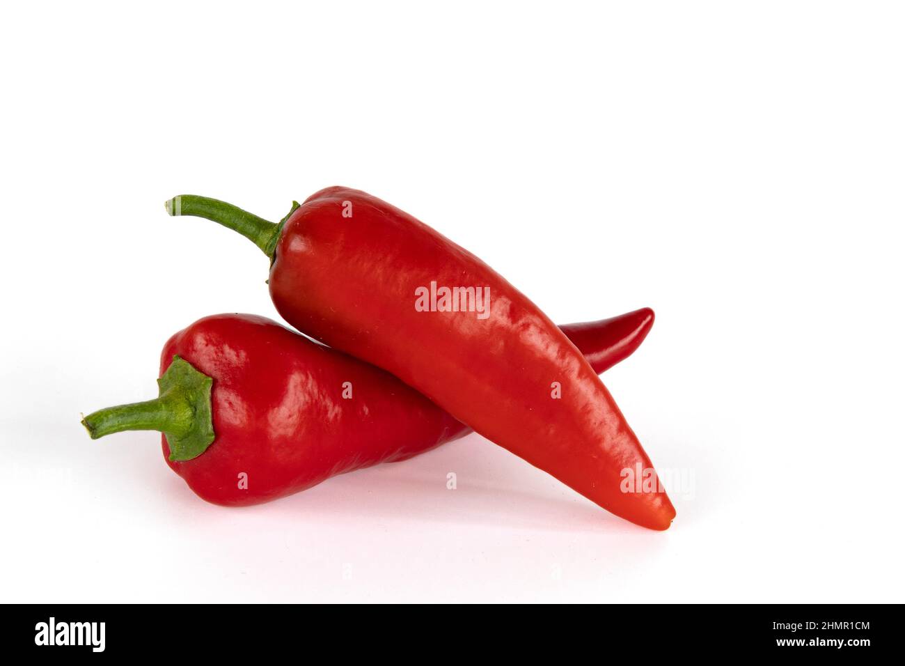 two red chili peppers isolated on white background, long sweet peppers ...