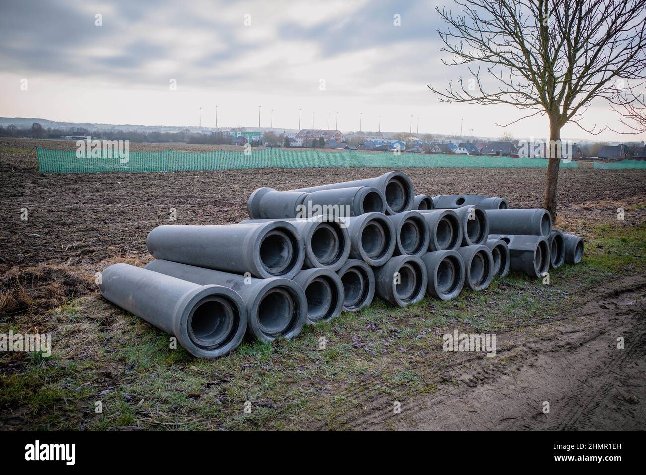 on a roadside there are concrete pipes that are to be laid Stock Photo ...