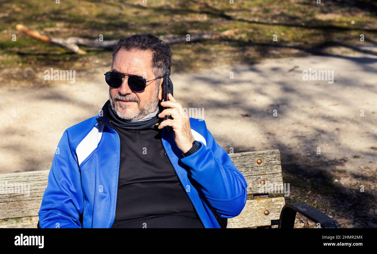 Middle-aged man making a phone call with his smart phone Stock Photo ...